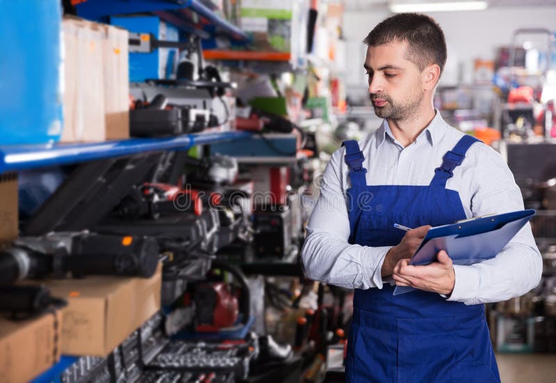 Man Making Rediscount in Tools Store Stock Photo - Image of rack ...