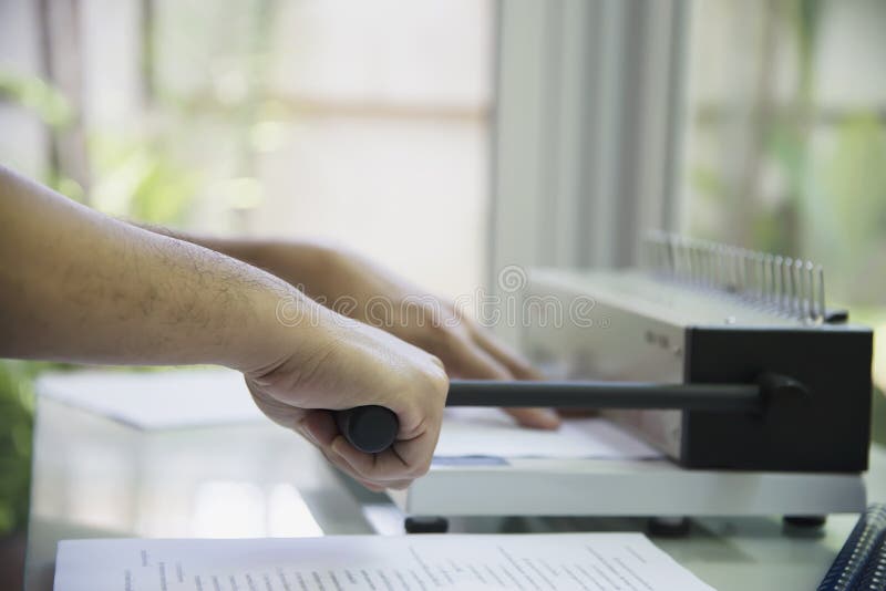 Man Making Report Using Comb Binding Machine Stock Photo - Image of ...
