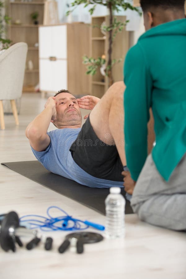 Man Making Sit-ups with Trainer in Fitness Private Class Stock Photo ...