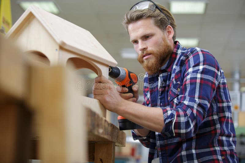 Man making house from wood stock photo. Image of toyhouse - 258545918