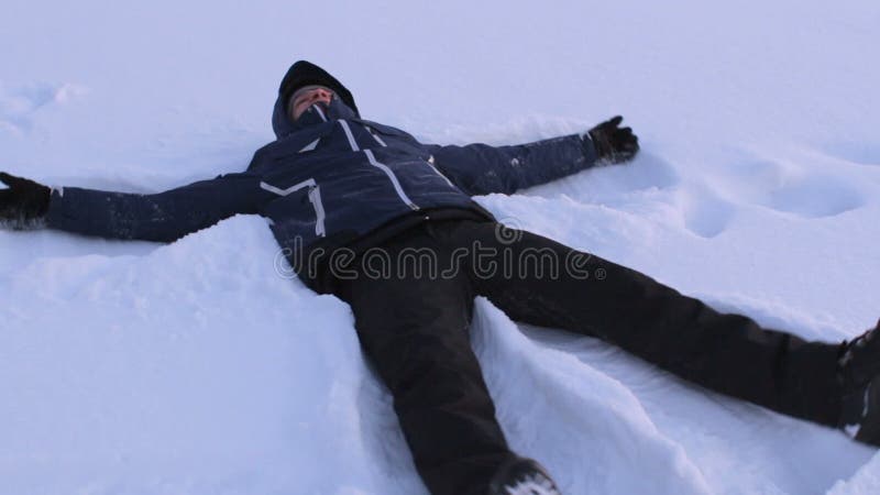 Man is Making Snow Angel in Deep Snow, Having Fun in Winter Stock Video ...