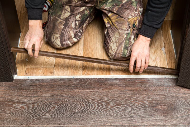 A Man is Making a Threshold on the Floor Stock Photo - Image of wooden ...