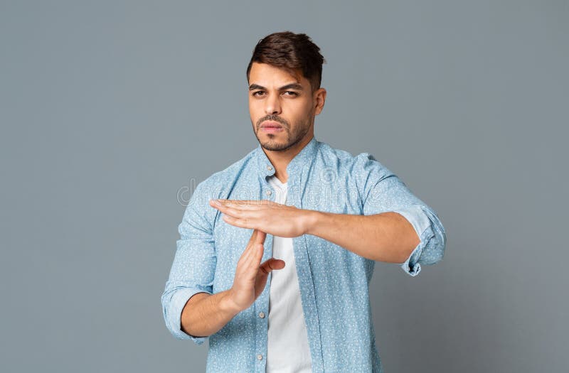Man Making Time Out Gesture on Gray Background Stock Photo - Image of ...