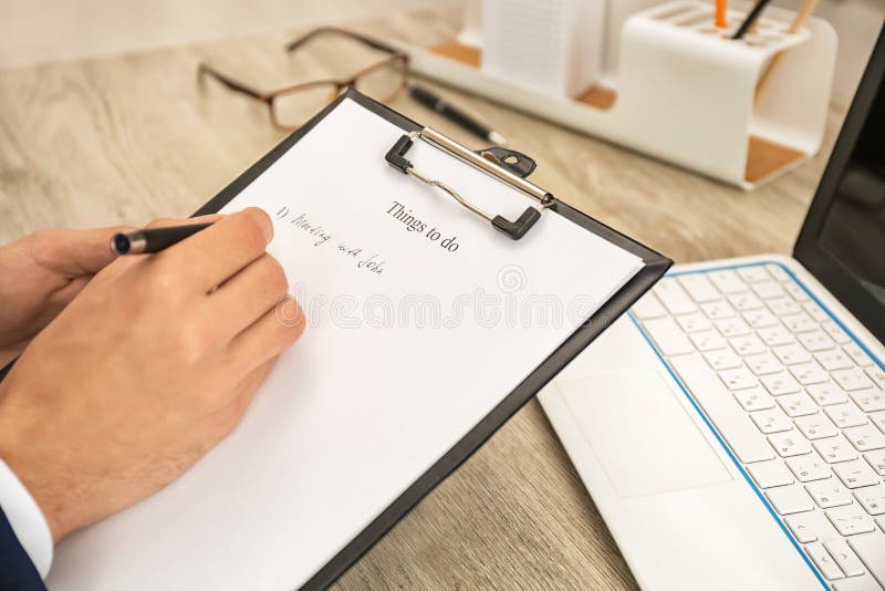Man Making To-do List while Sitting at Table, Closeup Stock Photo ...