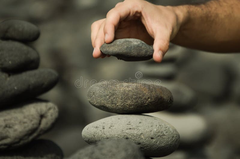 Man Making a Tower with Stones Stock Image - Image of stones, tower ...