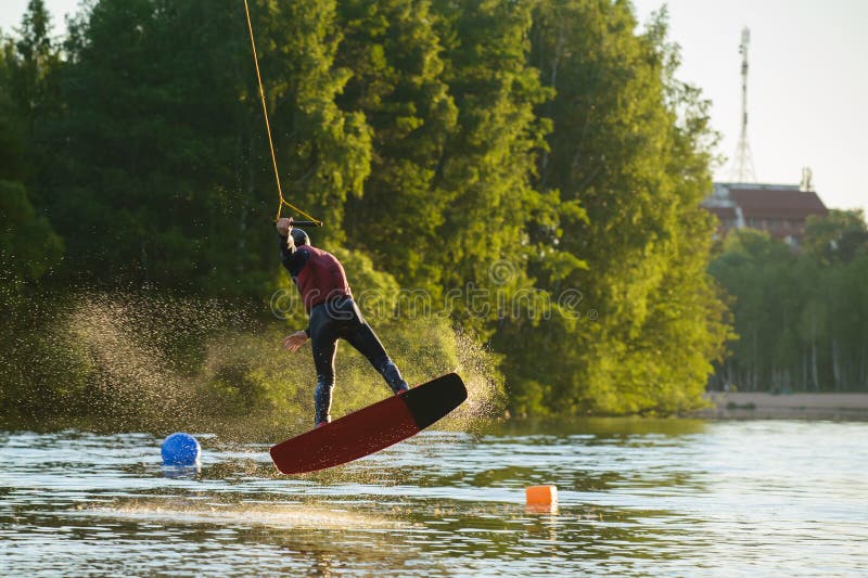 Man Wakeboarding and Jumping at Sunset Stock Image - Image of speed ...