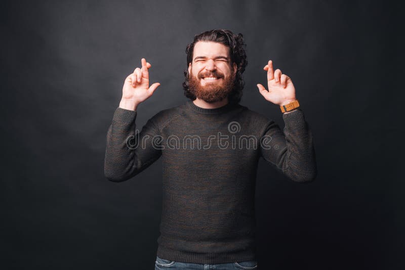 Man Making a Wish and Crossing Fingers Over Dark Background Stock Image ...