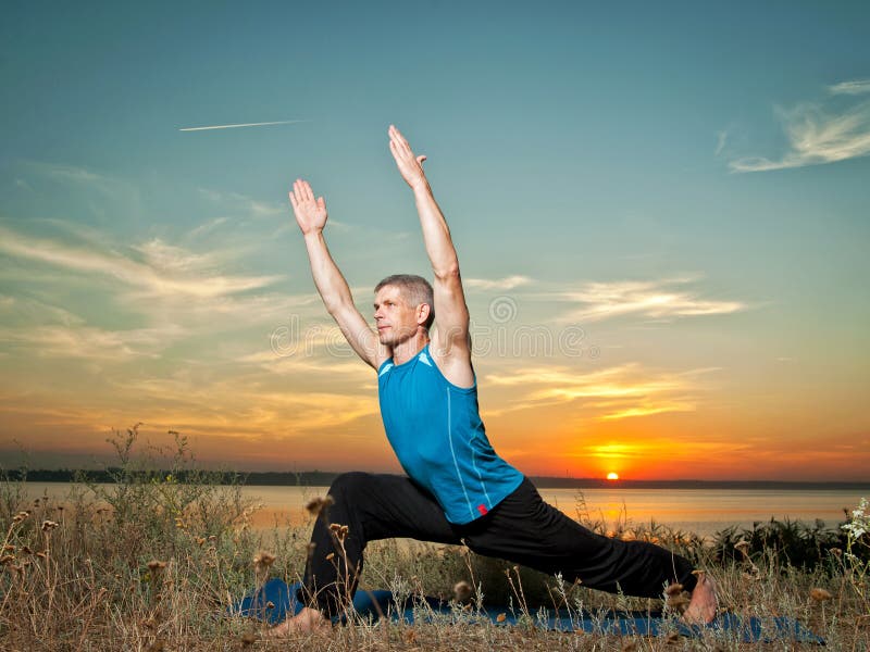 Man Making Yoga Exercises Outdoors Stock Photo - Image of wellness ...