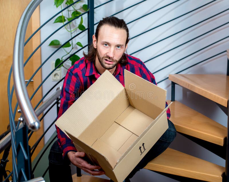 Man Man Sitting in Corridor with a Empty Box Stock Image - Image of ...