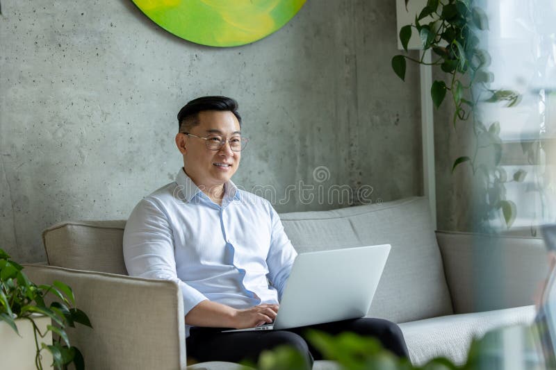 Man Manager Working Browsing the Web in His Laptop Computer while ...