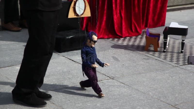 Man Manages Puppet Which Dance on Pavement at Stock Video - Video of ...