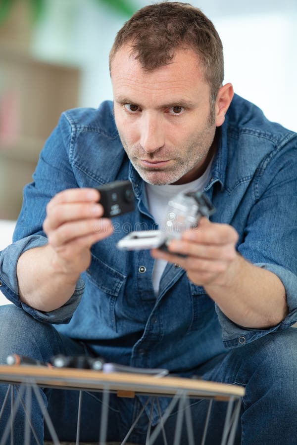 Man Manipulating Camera Battery and Charger Stock Image - Image of ...
