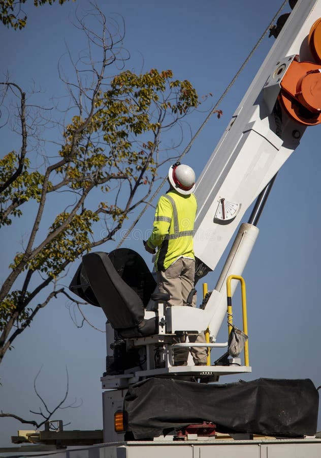 A Man on a Manlift Looking Up To Check on Work in Progress Stock Photo ...