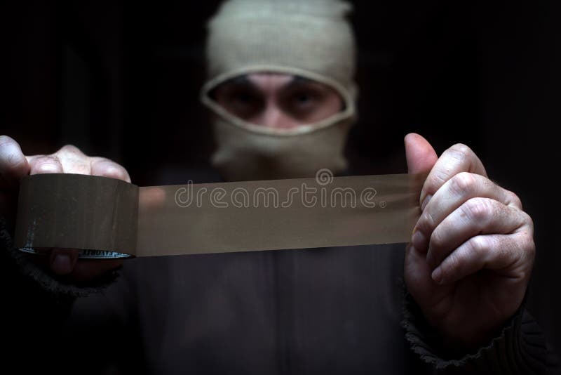 The Man in Mask and Duct Tape in His Hands. the Concept of Kidnapping ...