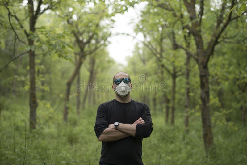 Man with Mask in Forest Posing with Crossed Arms Stock Image - Image of ...