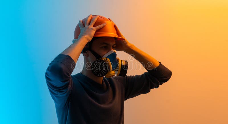 A Man in a Mask with a Filter and a Helmet Color Background Stock Image ...