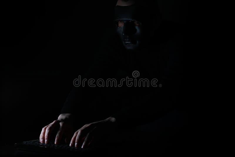 A Man in a Mask Prints on the Keyboard in the Dark Stock Image - Image ...