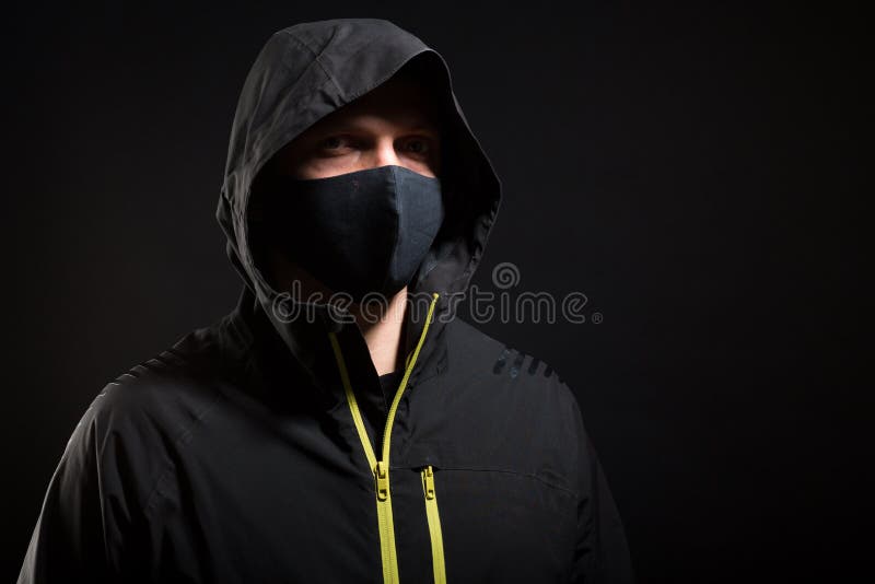 The Man in the Mask Puts on a Glove. Preparation for Robbery or Hacking ...