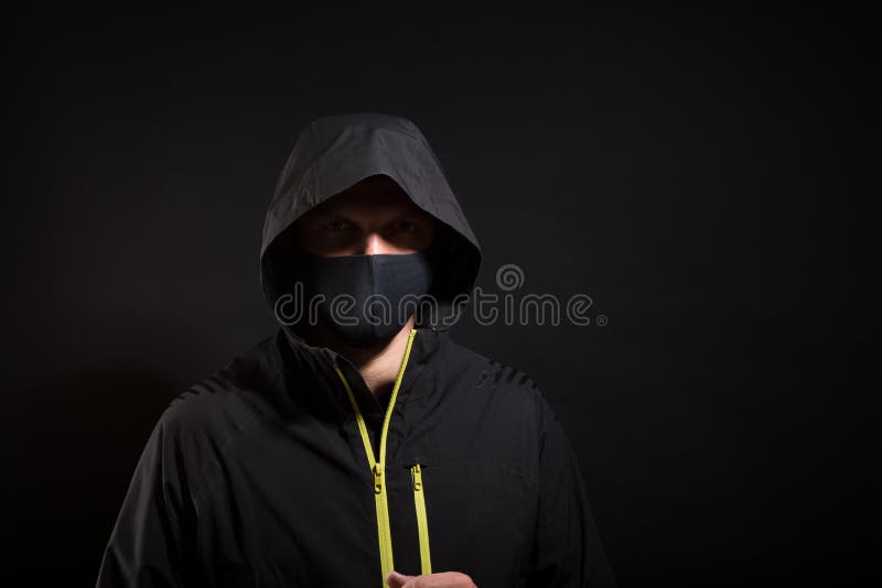 The Man in the Mask Puts on a Glove. Preparation for Robbery or Hacking ...