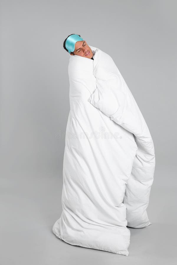 Man in Mask Wrapped with Blanket Sleeping on Grey Background Stock ...