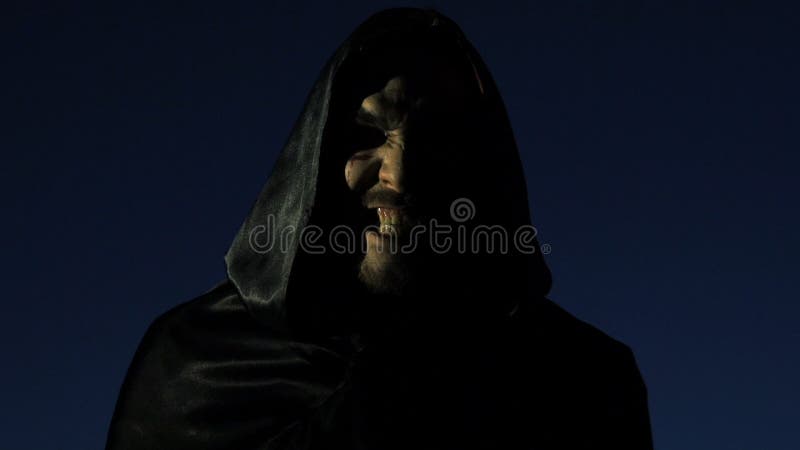 Man Masked in Terror in Raincoats Turning in Darkness Stock Video ...