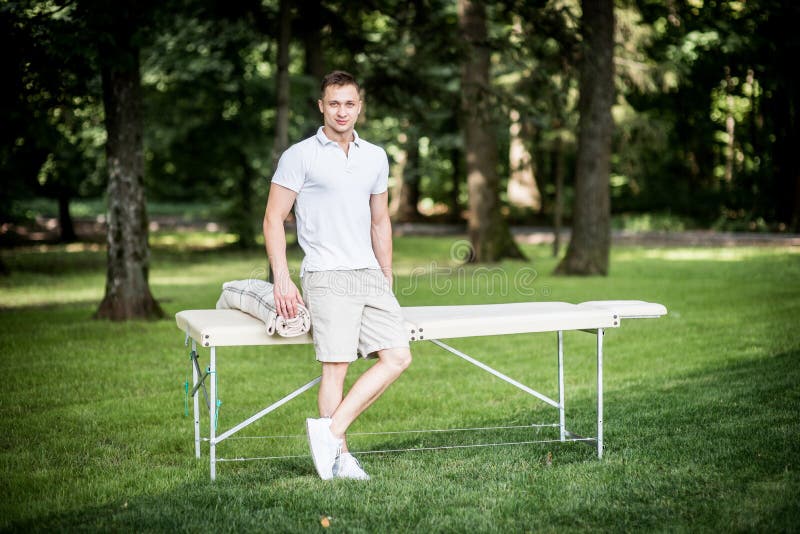 Man with Massage Table Outside, Stock Photo - Image of doctor ...