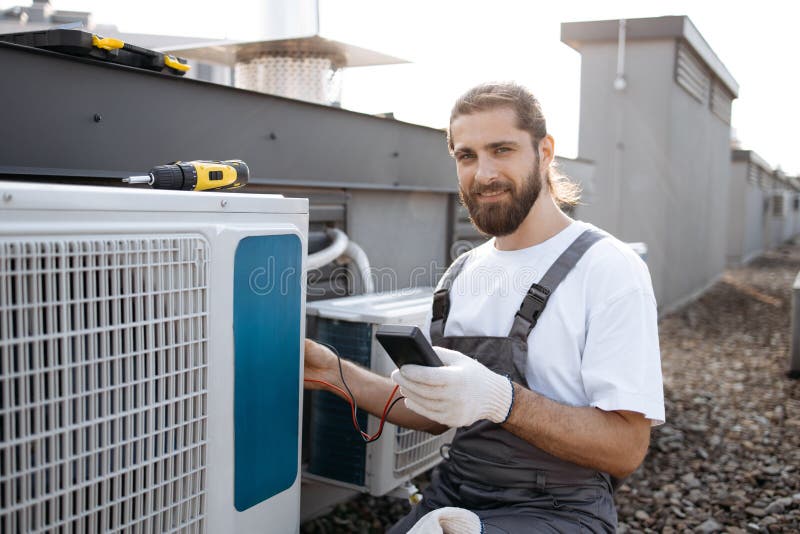 Man Master Fixing Conditioner and Using Multimeter on Roof Stock Photo ...