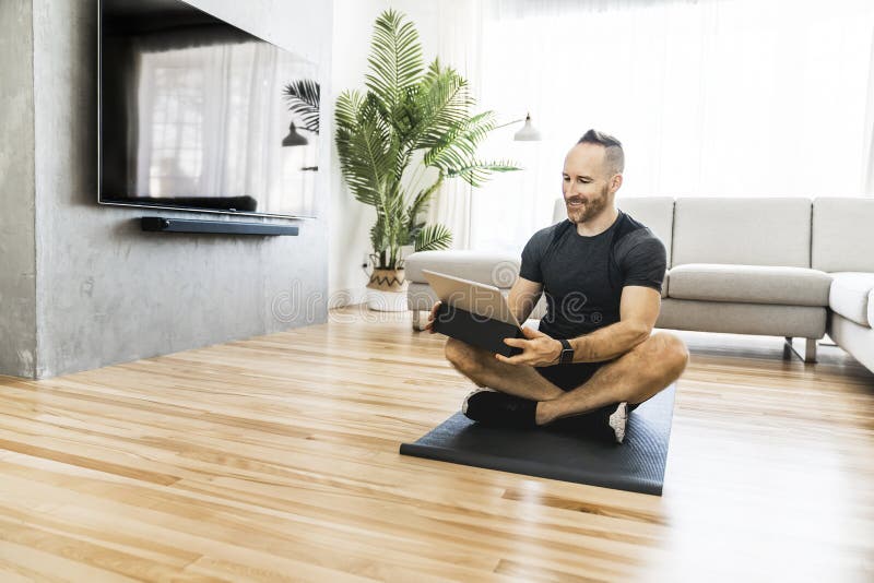 Man on a Mat with Tablet Doing Some Exercise at Home Stock Image ...