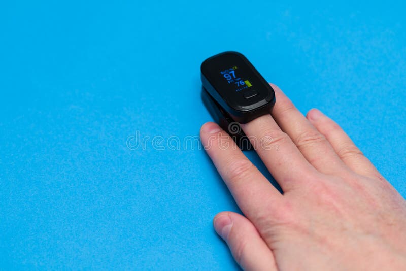 Man Measures the Level of Blood Oxygen Saturation Using a Device Stock ...