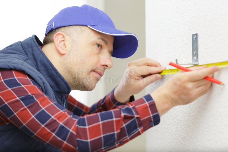 Man Measures on Wall with Ruler Stock Image - Image of adult, remodel ...