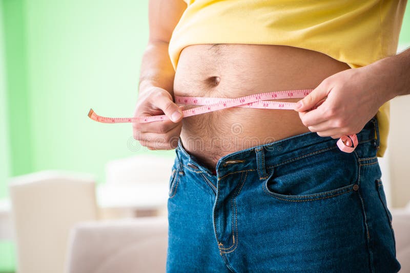 The Man Measuring Body Fat with Tape Measure in Dieting Concept Stock ... The Man Measuring Body Fat with Tape Measure in Dieting Concept Stock ...