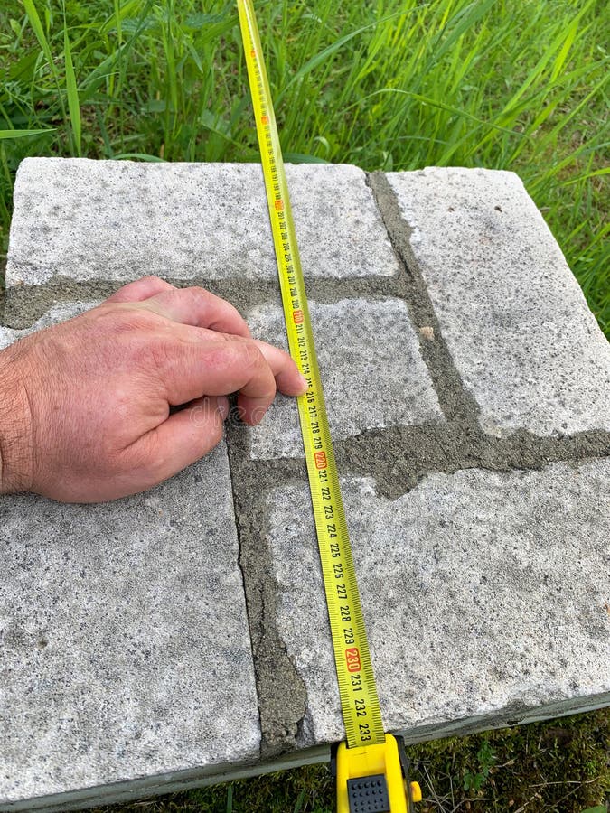 Man is Measuring a Brick with a Tape Measure Stock Image - Image of ...