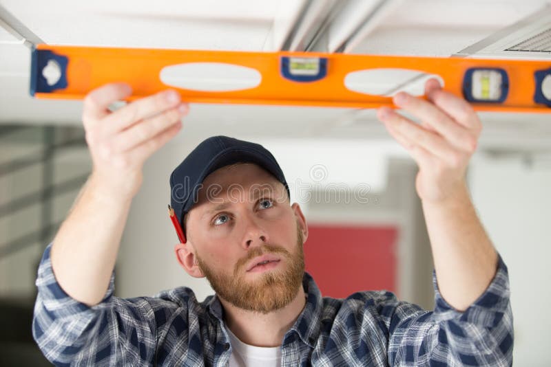 Man Measuring Ceiling with Sprit Level Stock Image - Image of ...