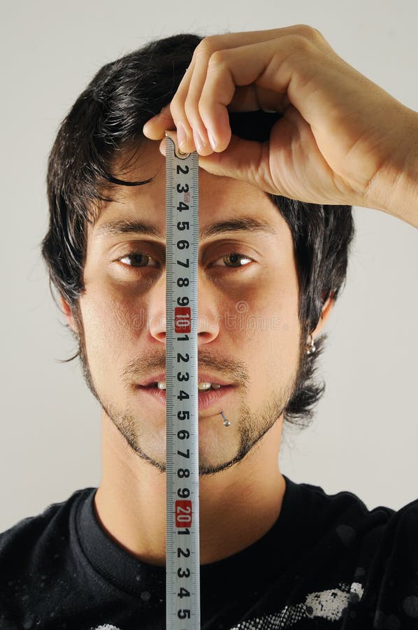 Man measuring his face stock photo. Image of holding, hand - 8970890