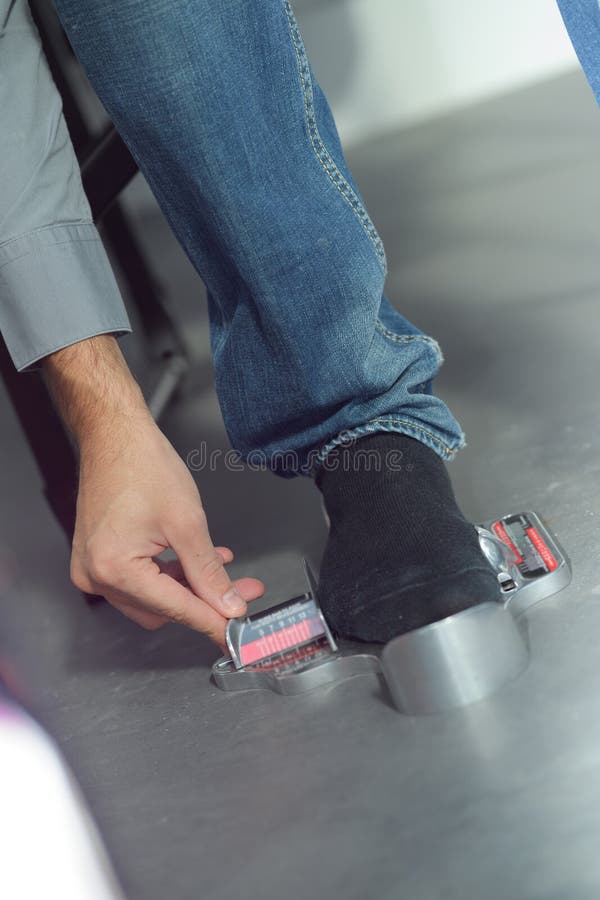 Man measuring his feet stock image. Image of buyer, client - 260780941