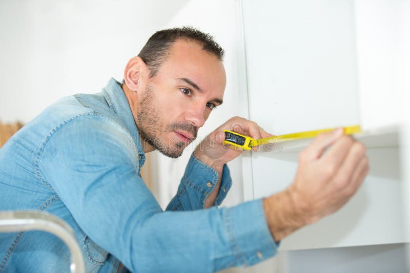 Man Measuring Kitchen Cupboard Stock Image - Image of handyman ...