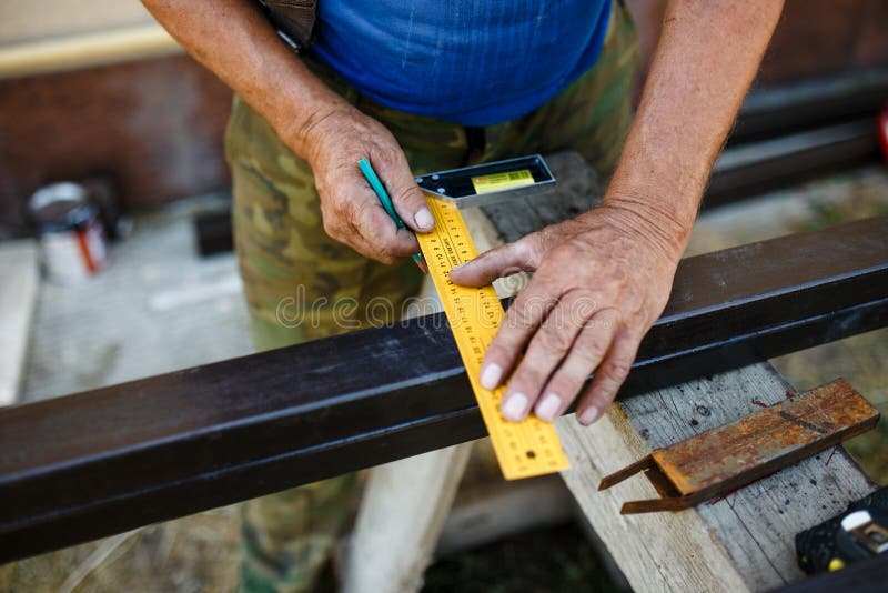 Man Measuring Off Metal Bar in Workshop. Stock Photo - Image of measure ...