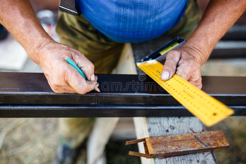 Man Measuring Off Metal Bar in Workshop. Stock Photo - Image of line ...
