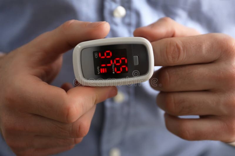 Man Measuring Oxygen Level with Modern Fingertip Pulse Oximeter ...