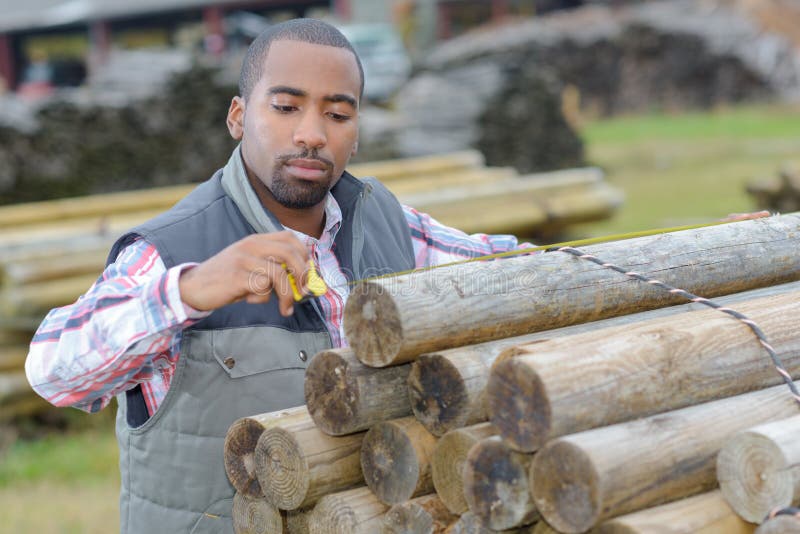 Man measuring posts stock photo. Image of cutter, fuel - 263373362