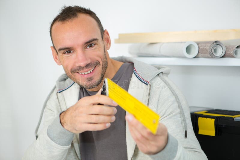 Man measuring something stock photo. Image of carpenter - 200446980
