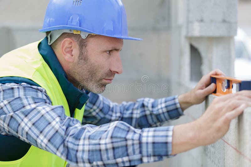 Man Measuring Wall with Construction Level Stock Image - Image of ...