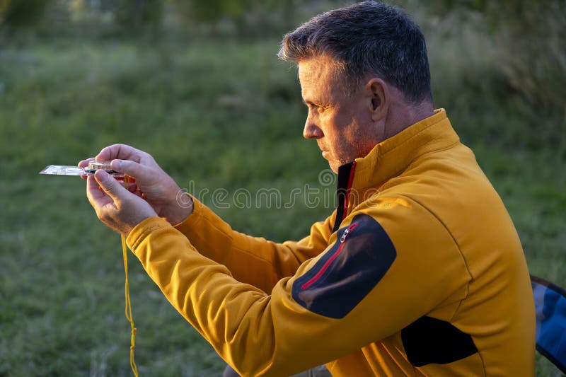 Man Measuring in Wilderness with Compass Stock Image - Image of life ...