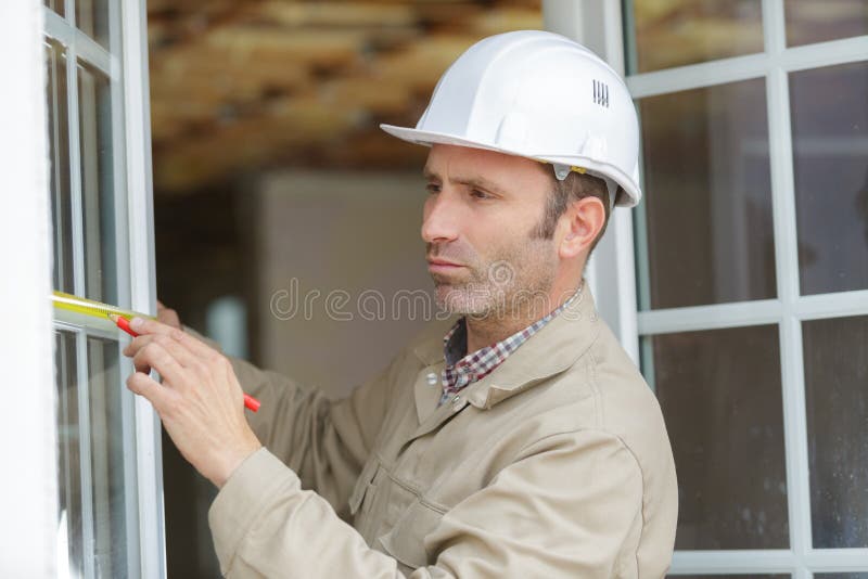 Man Measuring Window Prior To Installation Stock Photo - Image of ...