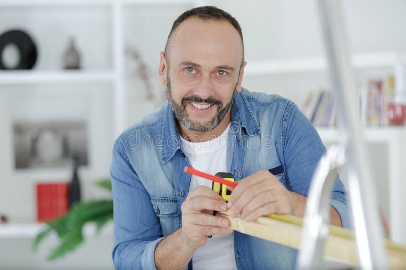 Man Measuring Wood Piece for Furniture Assembling Stock Image - Image ...