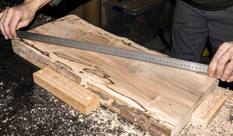 Man Carpenter Measuring Wooden Plank with Ruler on Carpentry Table ...