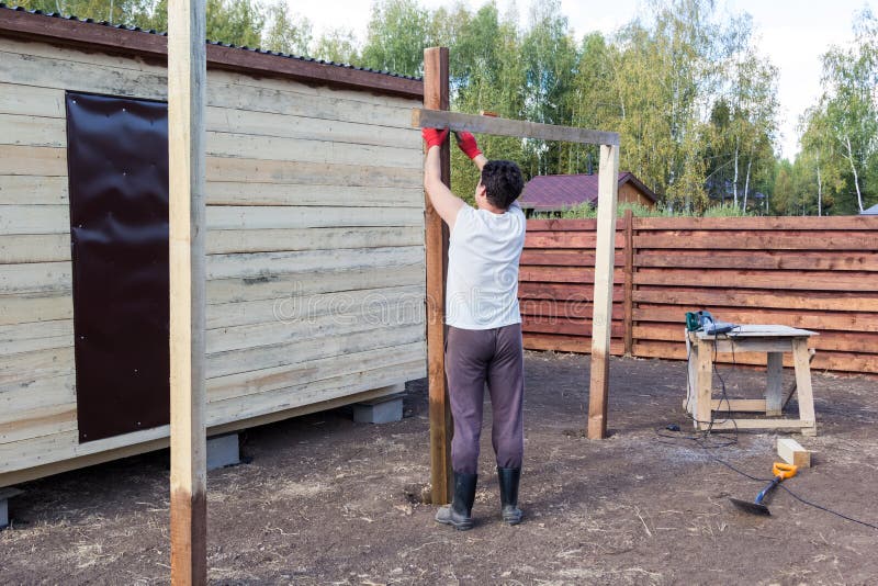 Man Measuring Wooden Post on the Level Stock Image - Image of measure ...