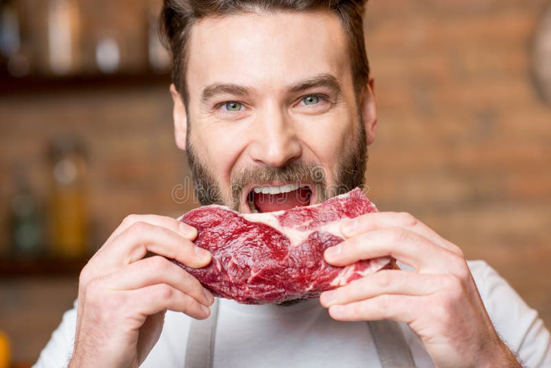 Man with meat stock photo. Image of handsome, biting - 85049202
