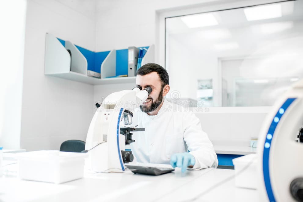 Medic Working with Microscope at the Laboratory Stock Image - Image of ...