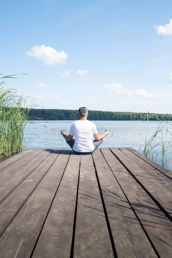 Man meditating near river. stock image. Image of river - 285774265